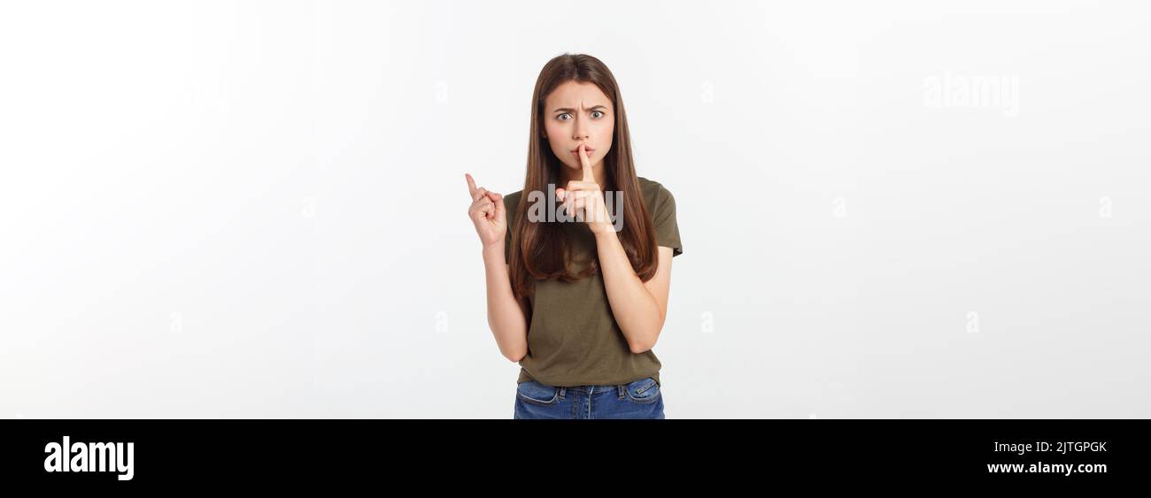Beautiful woman showing finger over lips isolated on a white background ...
