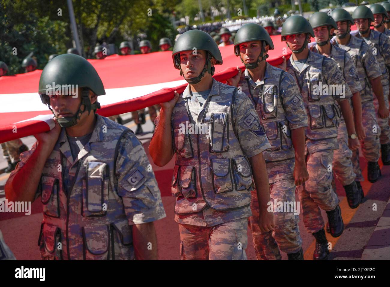 Turkish soldiers march with a Turkish flag during the military parade ...