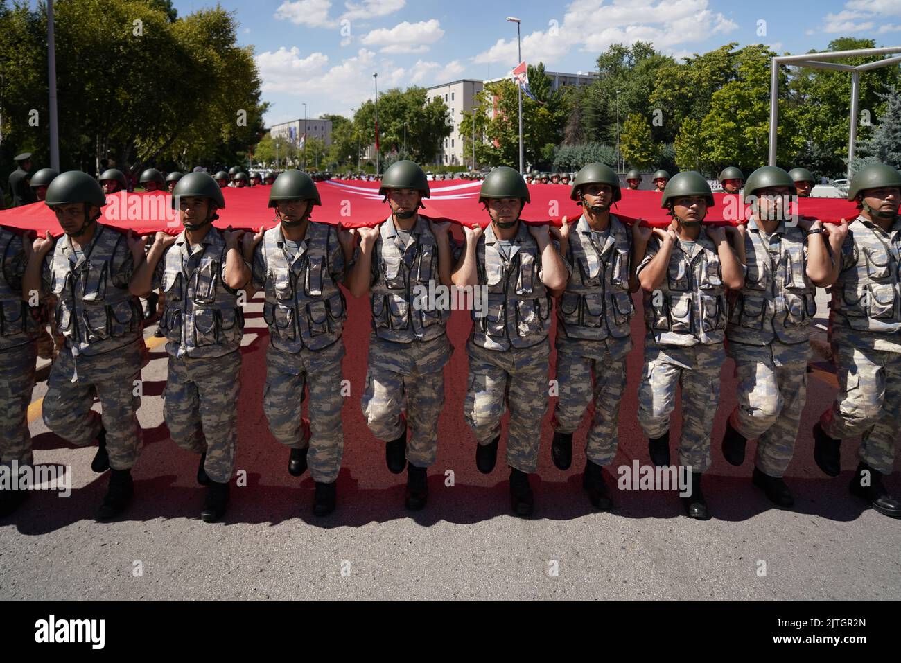Turkish soldiers march with a Turkish flag during the military parade ...