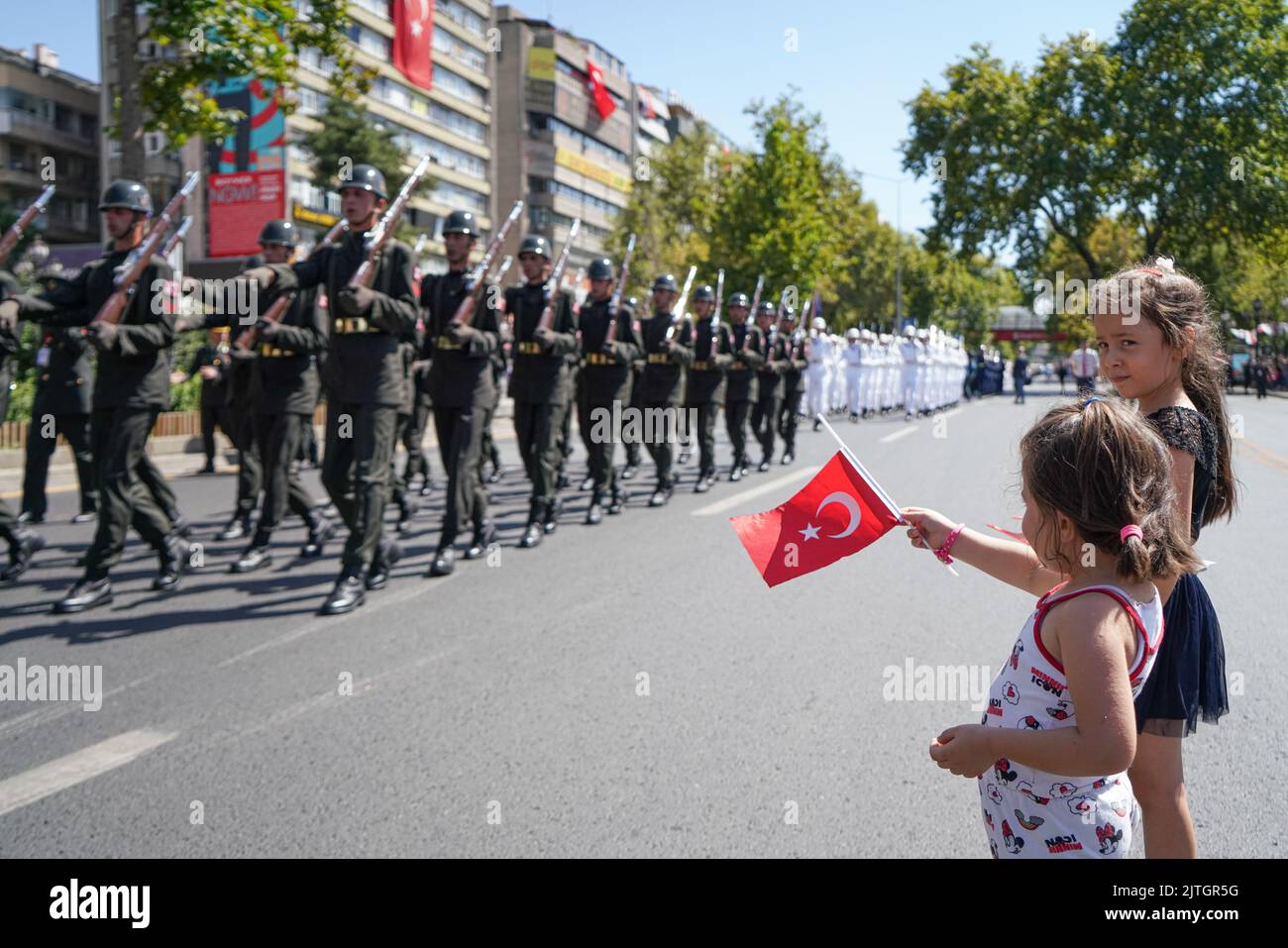 Two girls salute the soldiers during the military parade. Victory Day ...