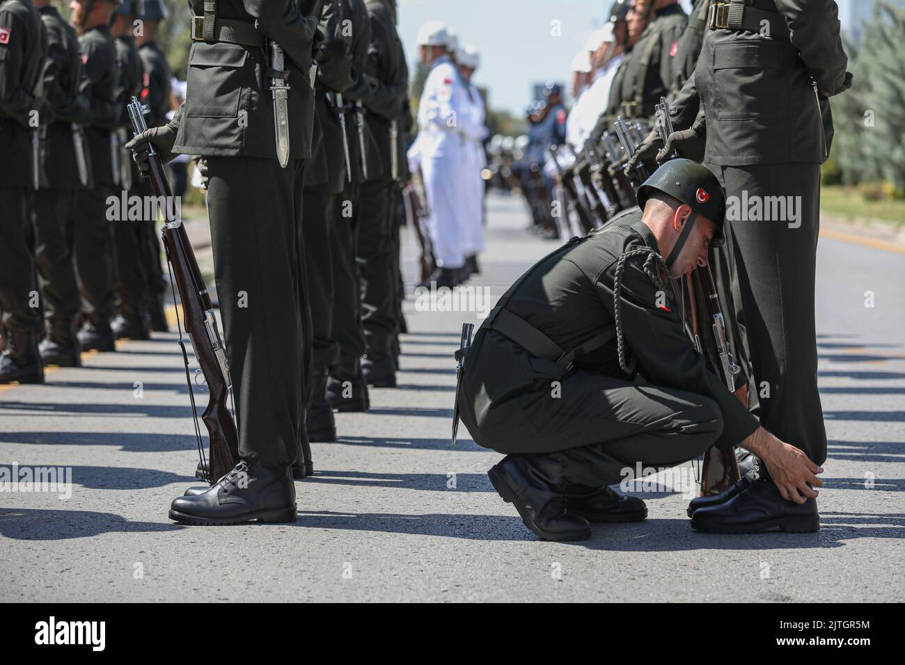 A Turkish soldier straightens his friend's shoes. Victory Day is an ...