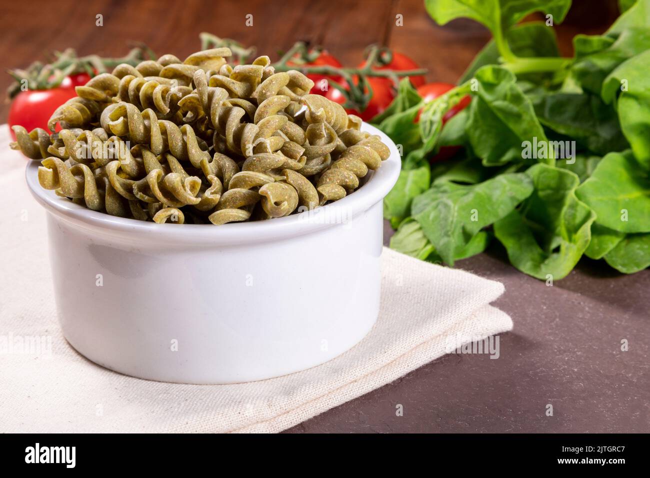 Raw spinach screw noodles, vegetarian, vegan . Healthy food Stock Photo ...