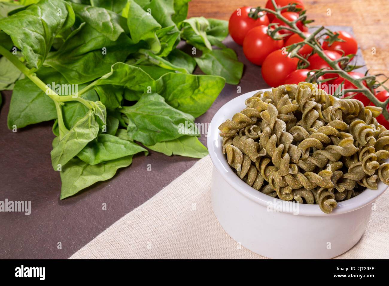 Raw spinach screw noodles, vegetarian, vegan . Healthy food Stock Photo ...