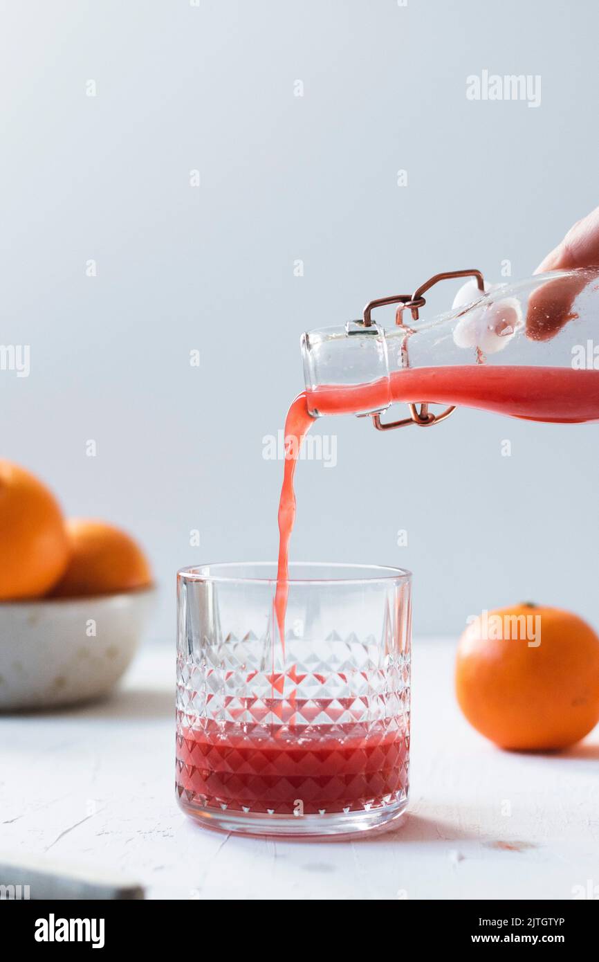 Orange juice being poured in to a glass Stock Photo - Alamy