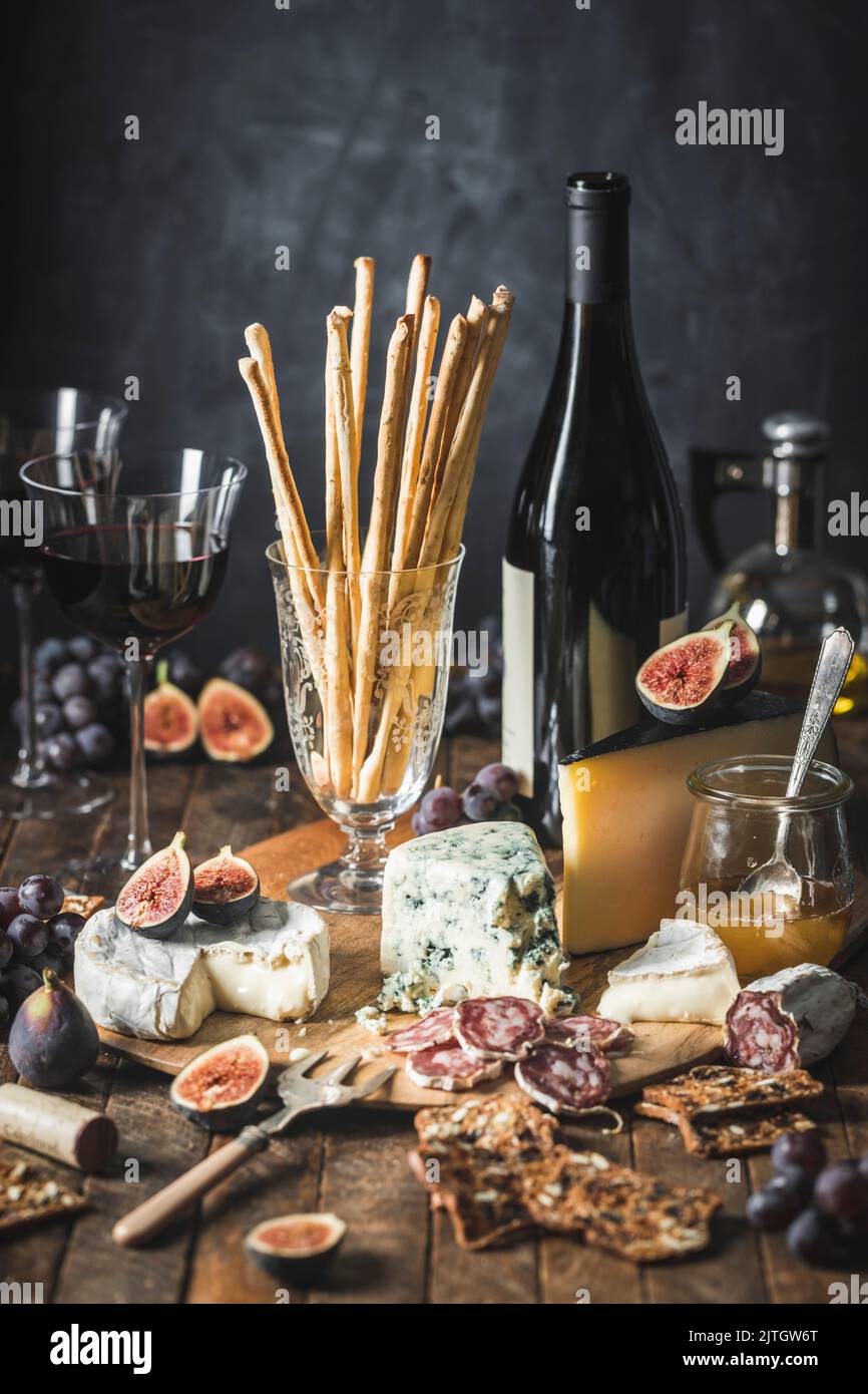 Elegant cheese and charcuterie spread with fresh figs and crackers with ...