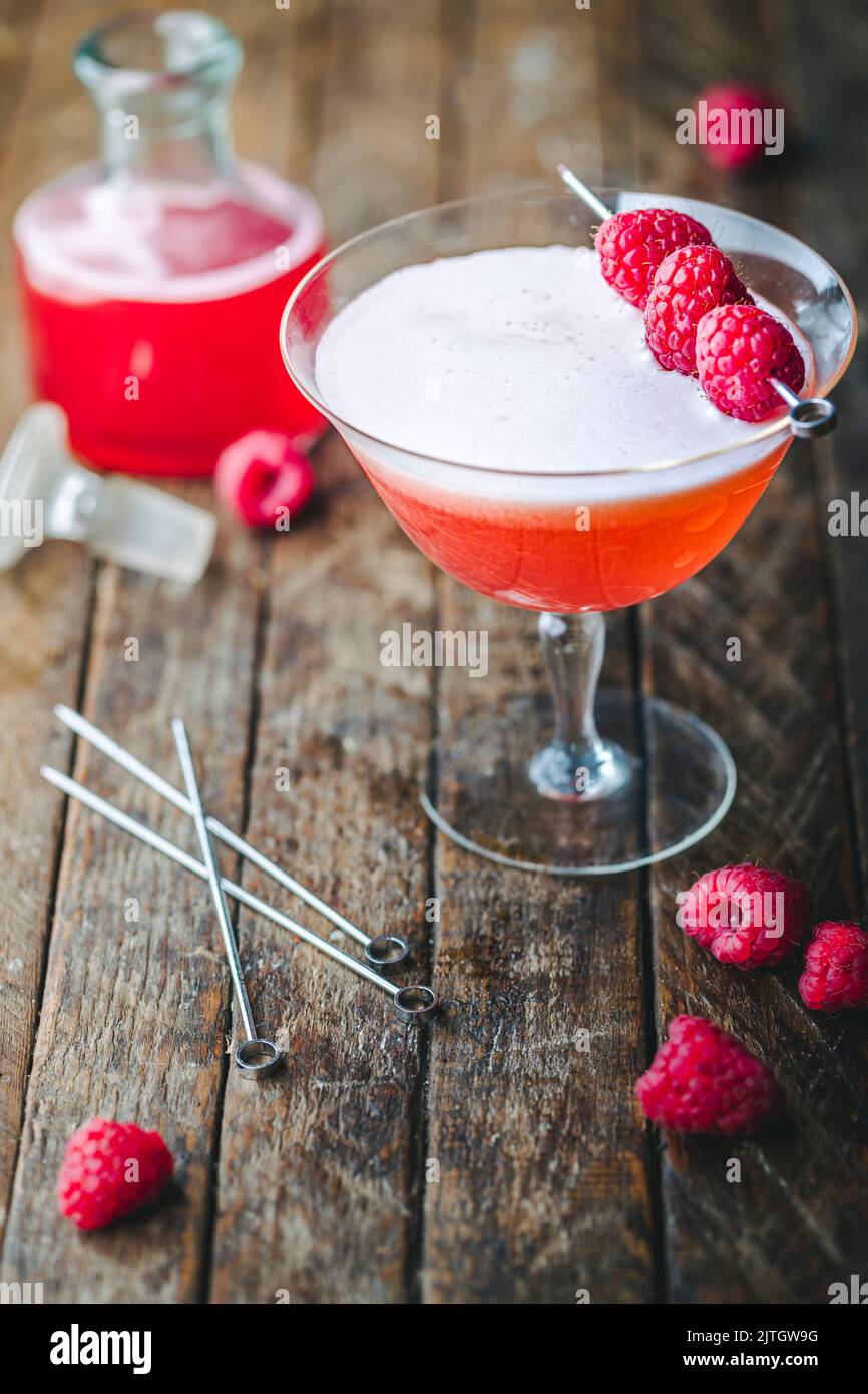 Raspberry Cocktail in vintage glass with fresh raspberry garnish and ...