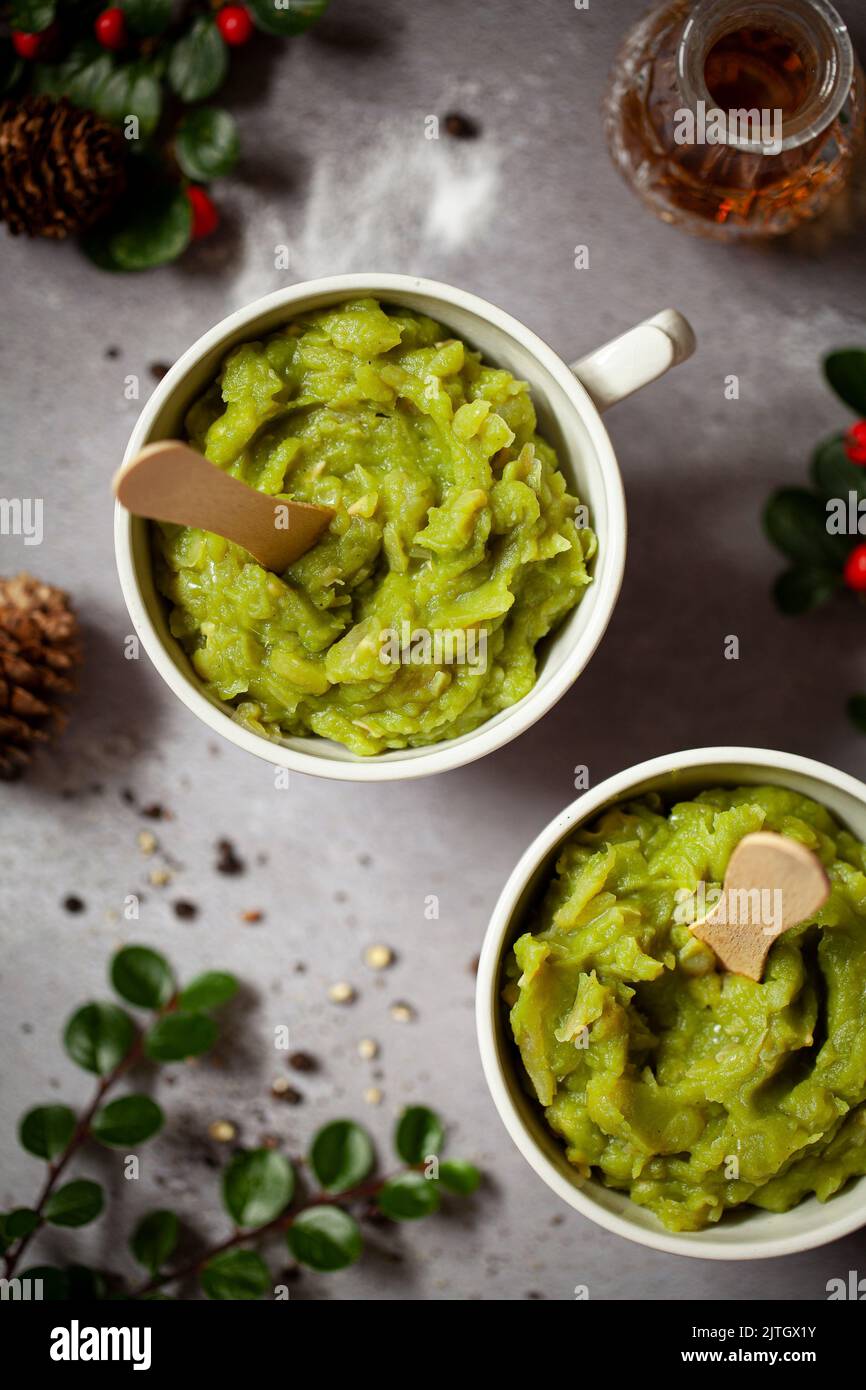 Servings of mushy peas with wooden chip shop forks Stock Photo - Alamy