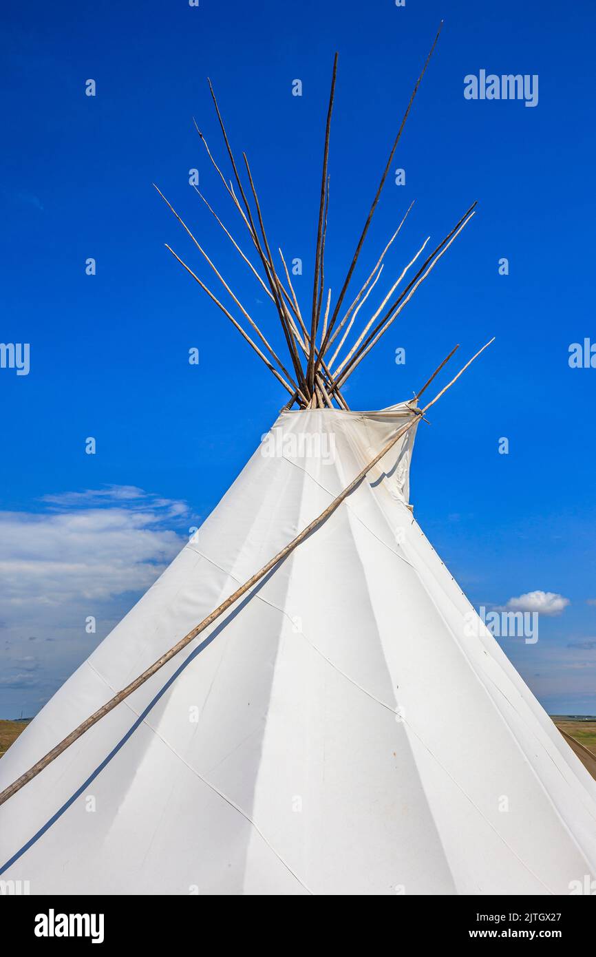 A conical tipi (or teepee) built with canvas stretched over a frame of ...