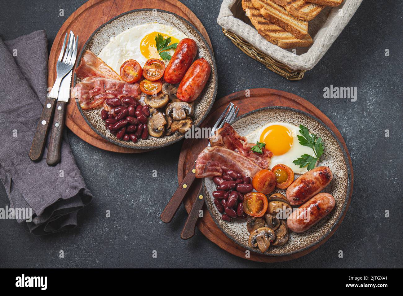 Traditional full English breakfast with fried eggs, sausages, beans ...