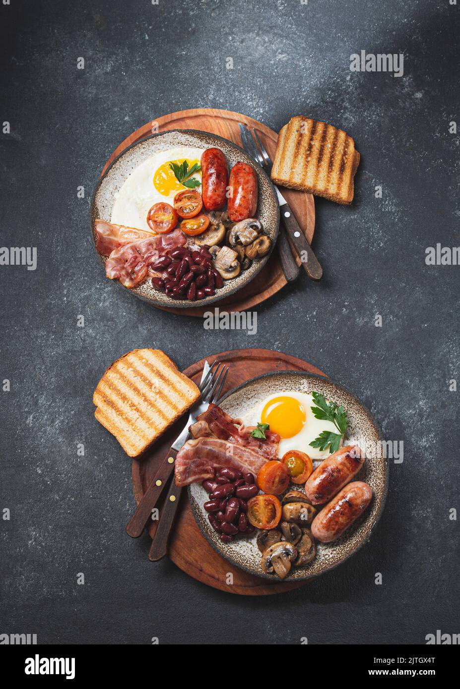 Traditional full English breakfast with fried eggs, sausages, beans ...