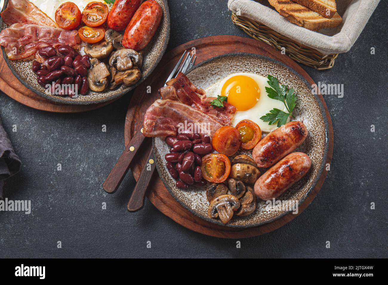Traditional full English breakfast with fried eggs, sausages, beans ...
