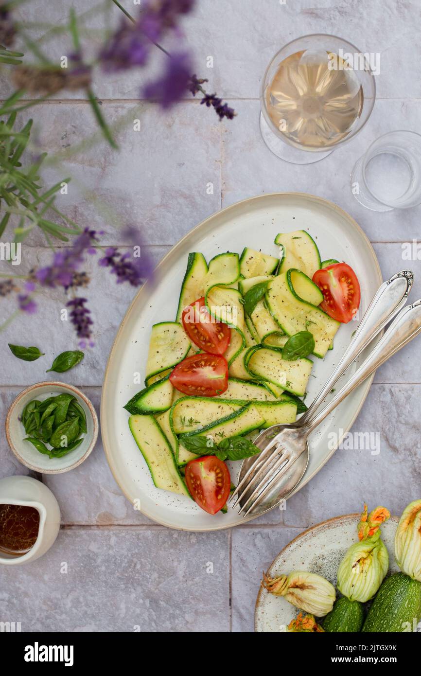 Courgette ribbons with tomaotes, basil and vinaigrette Stock Photo - Alamy