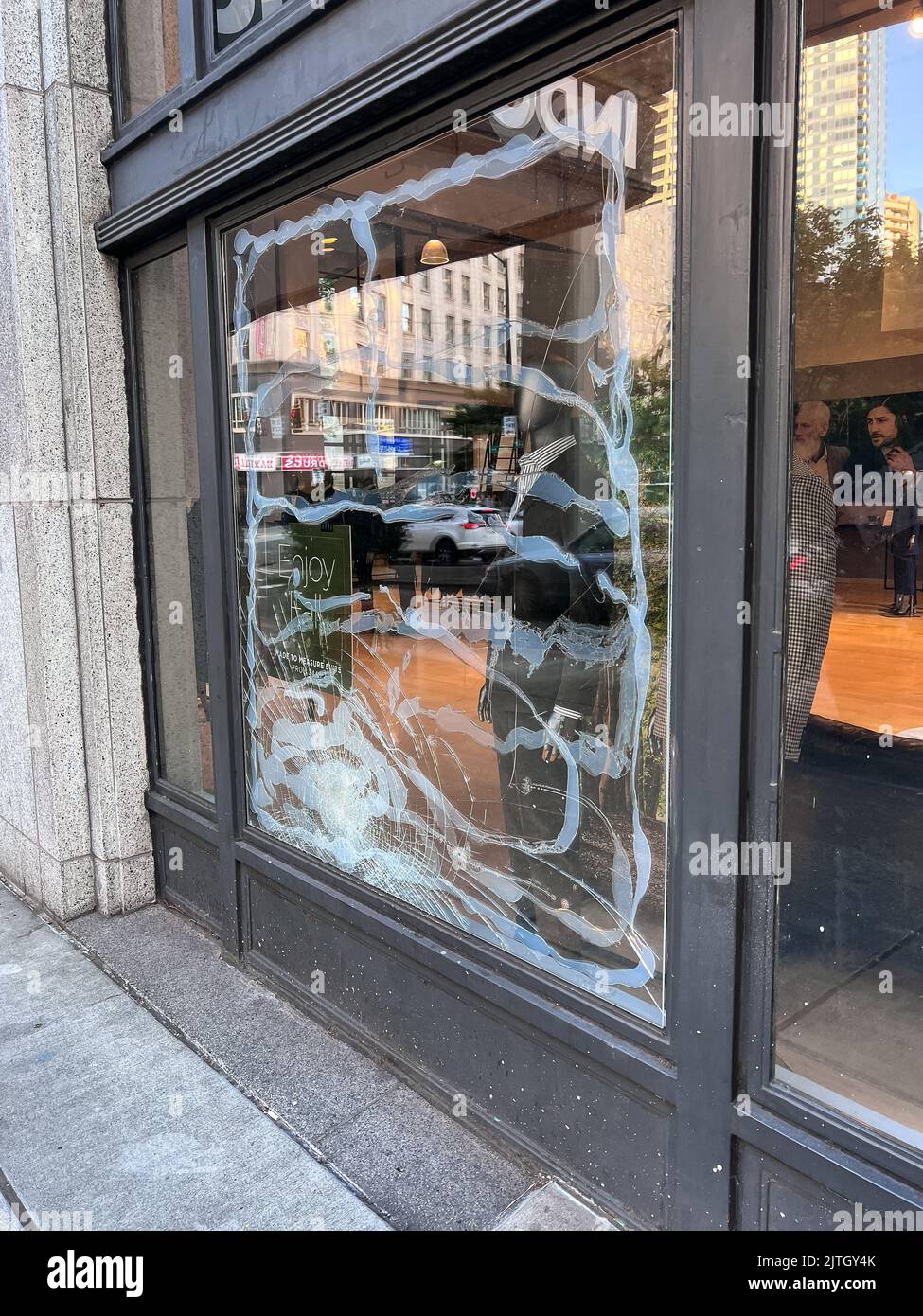 Seattle, USA. 25 Aug, 2022. A smashed window in the Westlake shopping ...