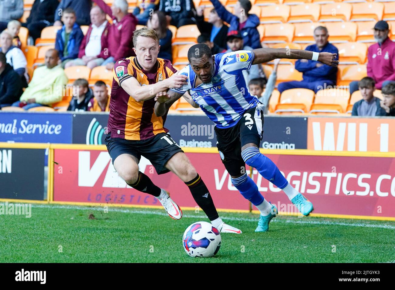 Luke Hendrie #17 of Bradford City holds back Jaden Brown #3 of ...