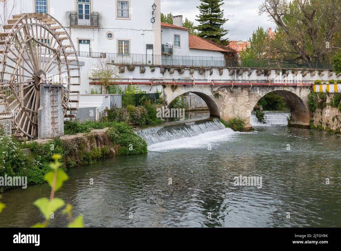 The old water wheel and the bridge by River Almonda in the old city of ...