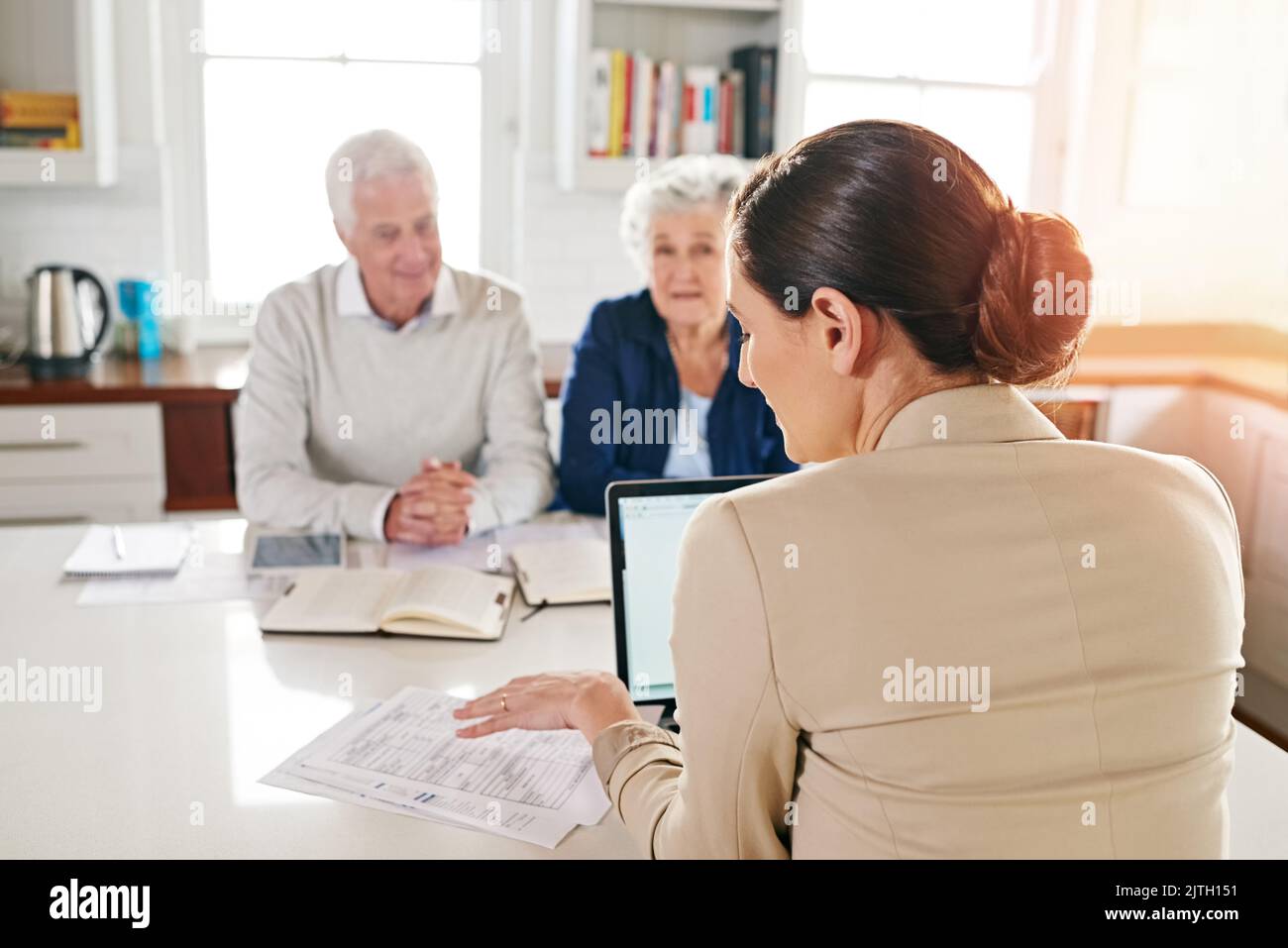 Helping to make their money work for them. a senior couple getting ...