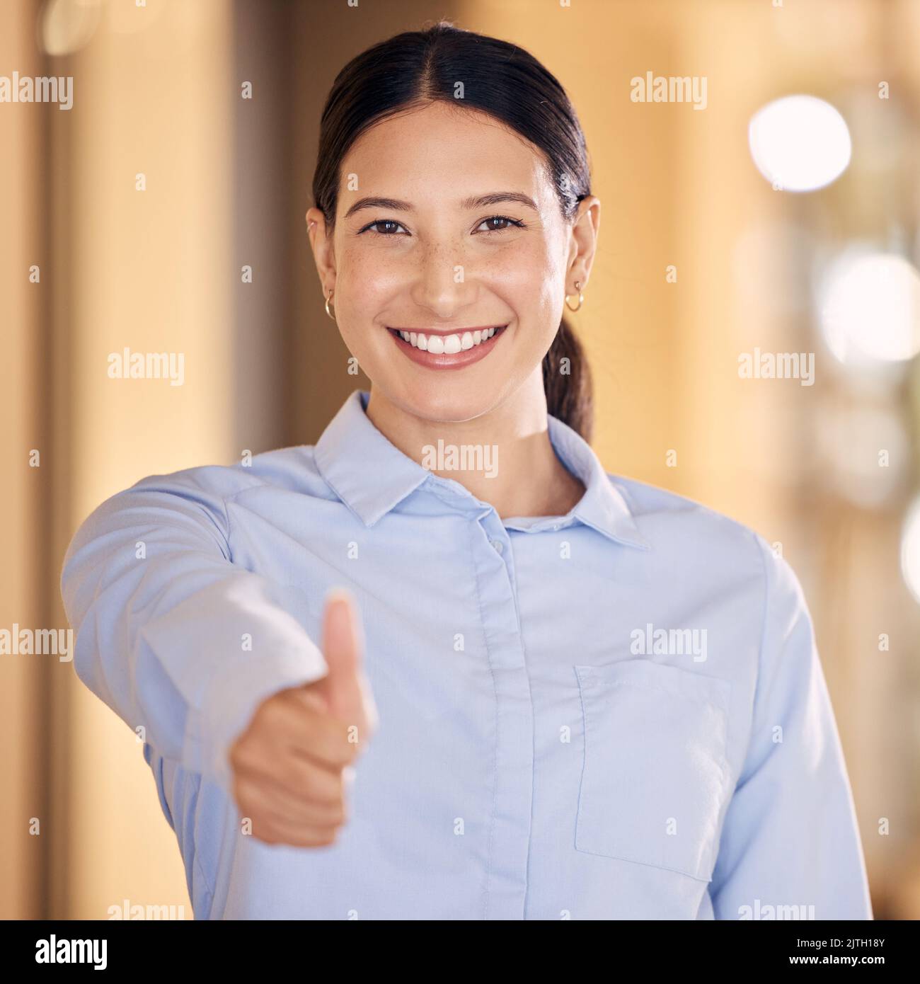 Thumbs up hand sign for success, employee motivation and excited business woman in an office at ...