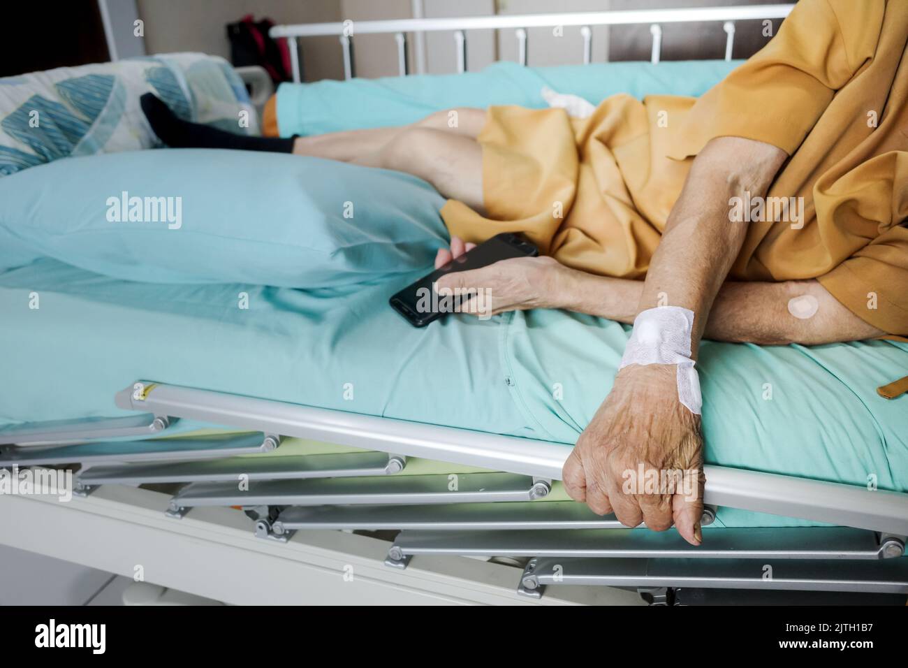 Sick Asian female senior patient with respiratory disorder having ...