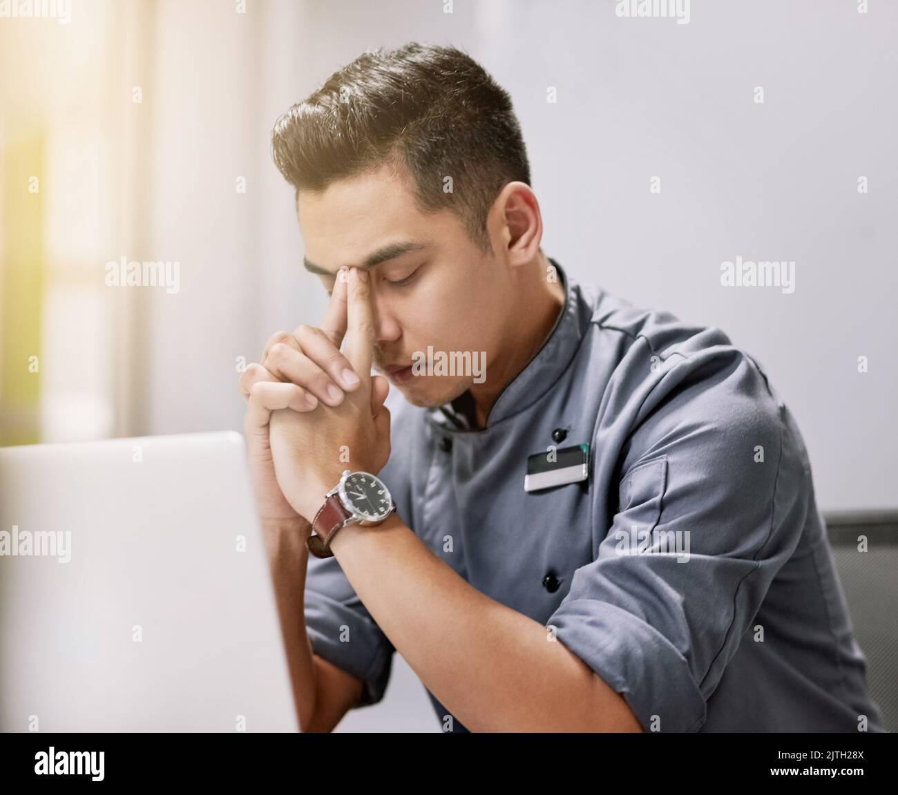 Feeling a little bit of pressure. a young man looking stressed while ...