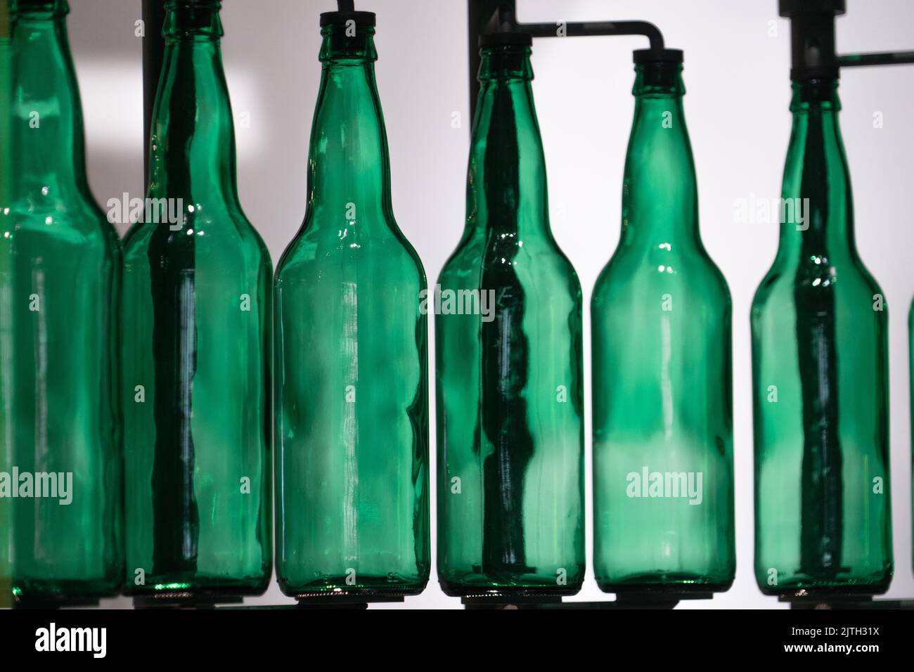 Row of see through green bottles Stock Photo - Alamy