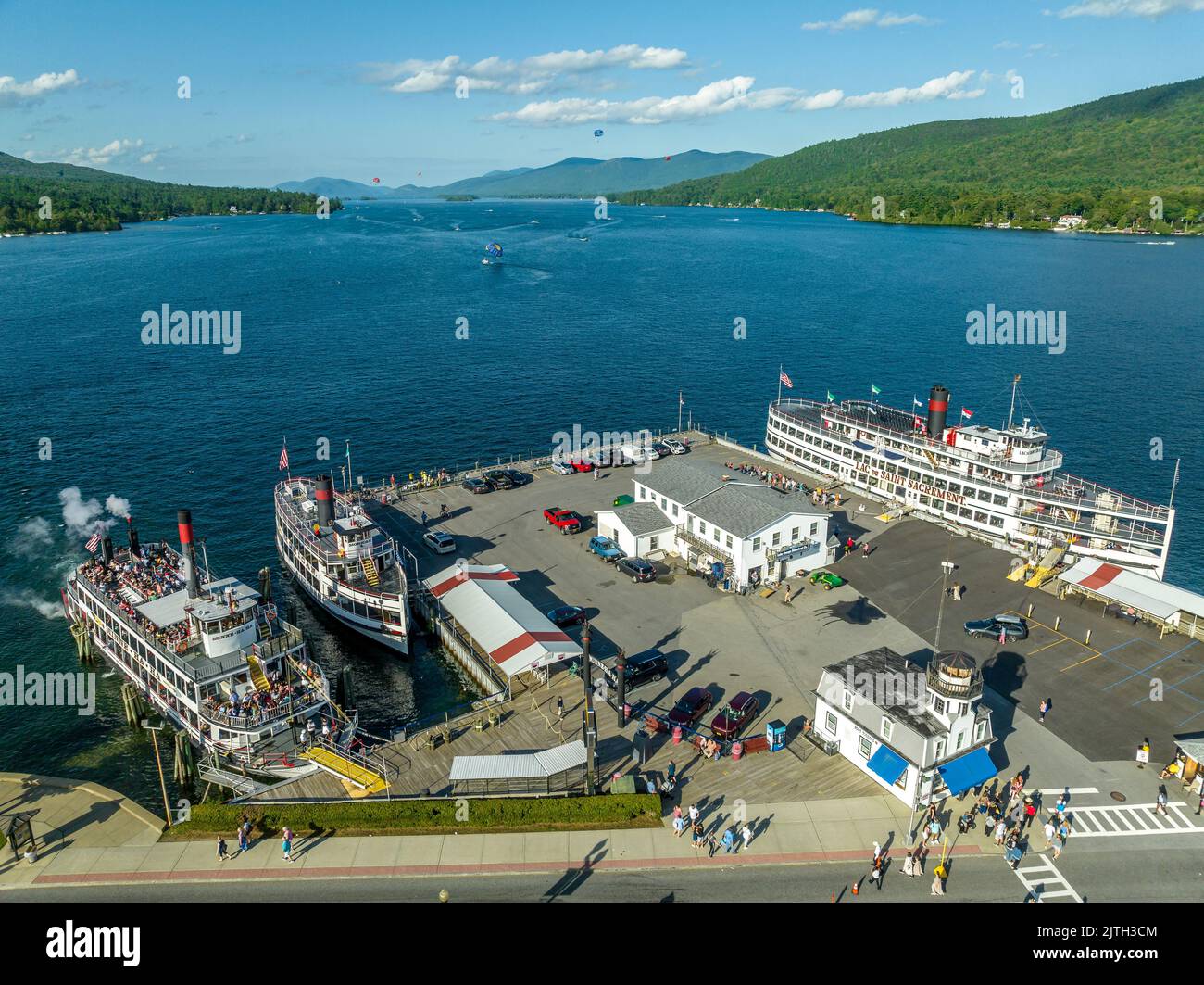 Aerial view of Lake George with hordes of tourists embarking on the ...