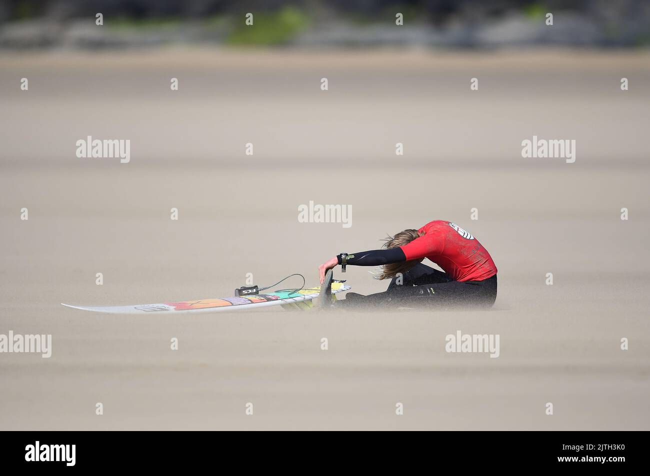Surfer doing warm up exercises on the beach Stock Photo - Alamy
