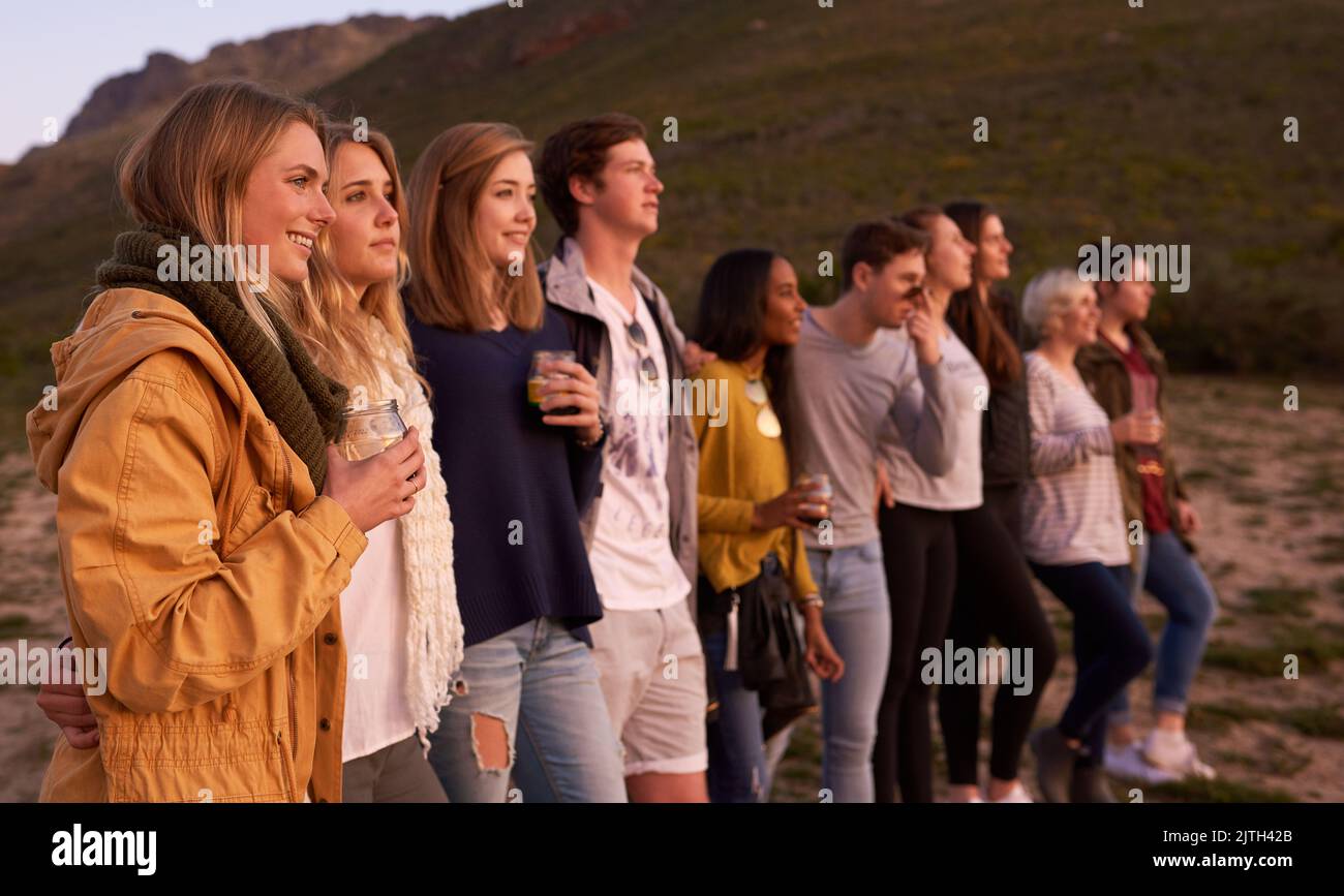 Sharing an unforgettable sunset. a group of friends admiring the ...
