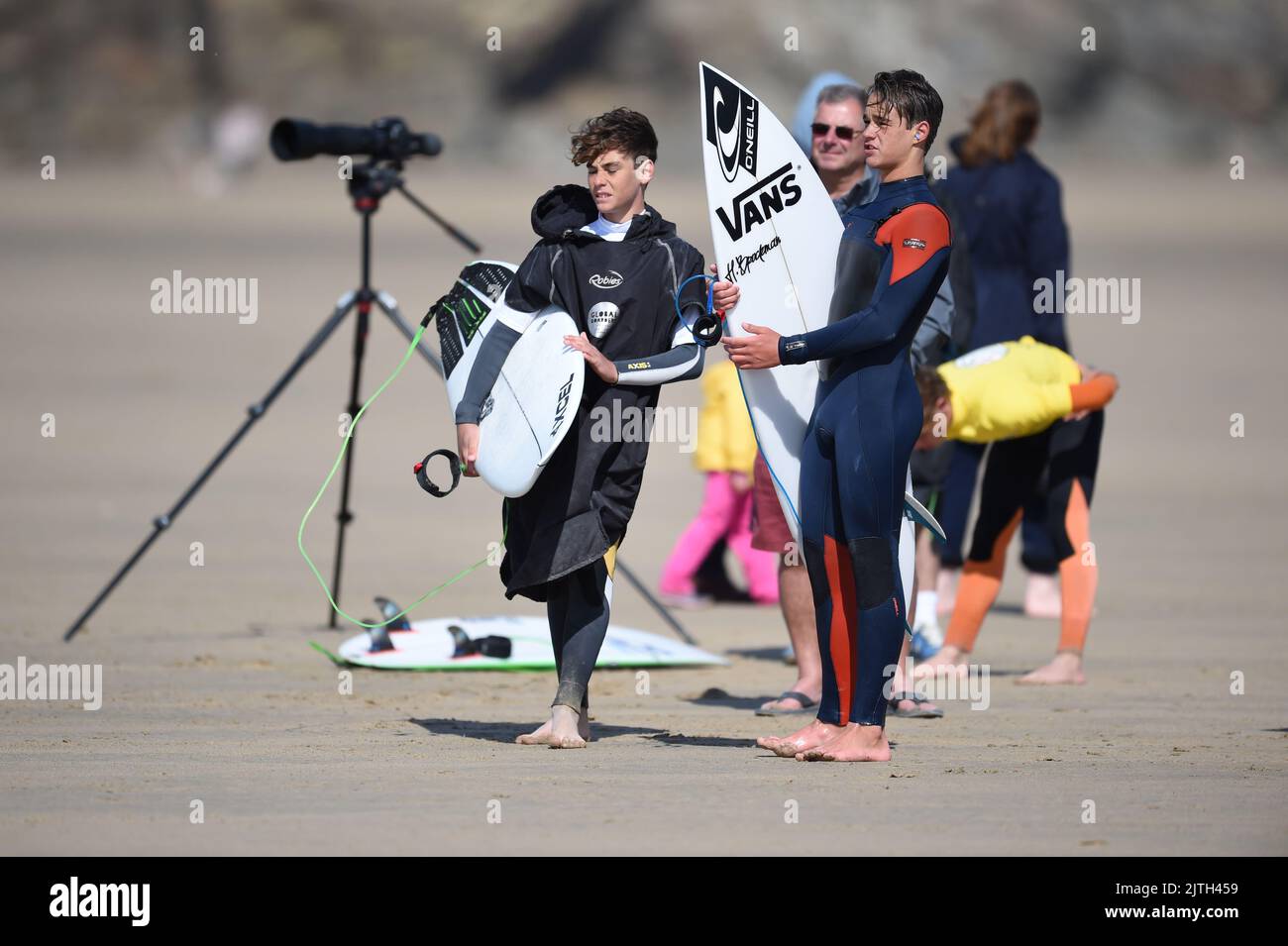 Surfers Surfing and camera on tripod Stock Photo - Alamy