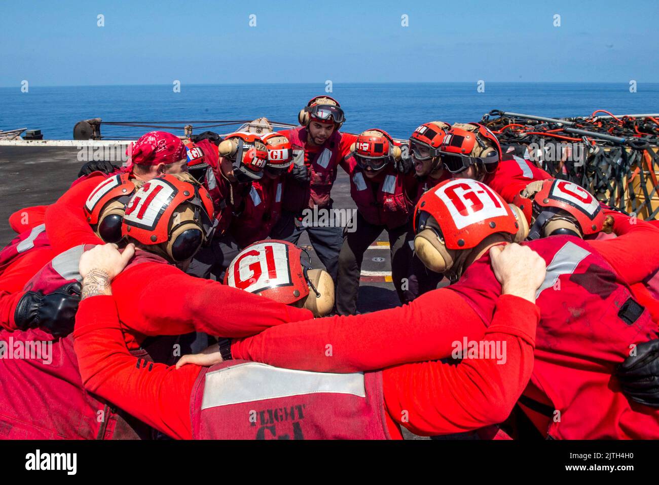 Ionian Sea. 27th Aug, 2022. Sailors huddle on the flight deck of the ...