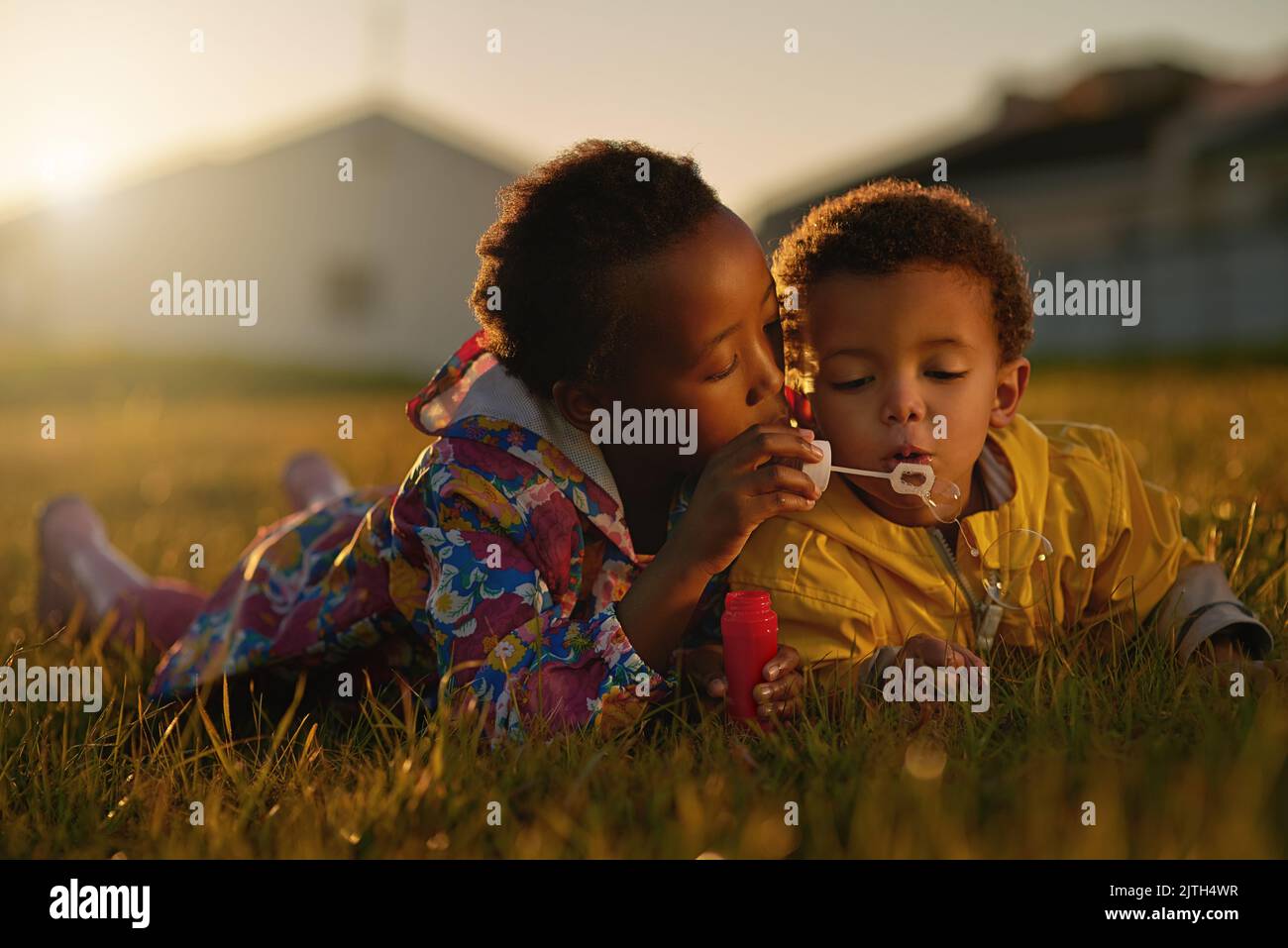 Making brother and sister memories. a brother and sister lying on the ...