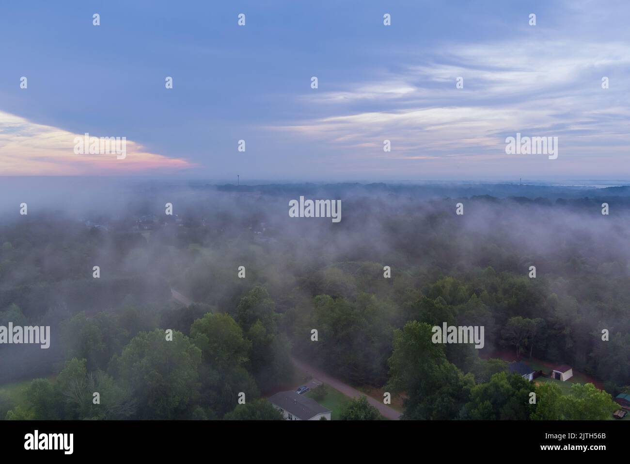 During the summer season in South Carolina, the morning fog in the town ...