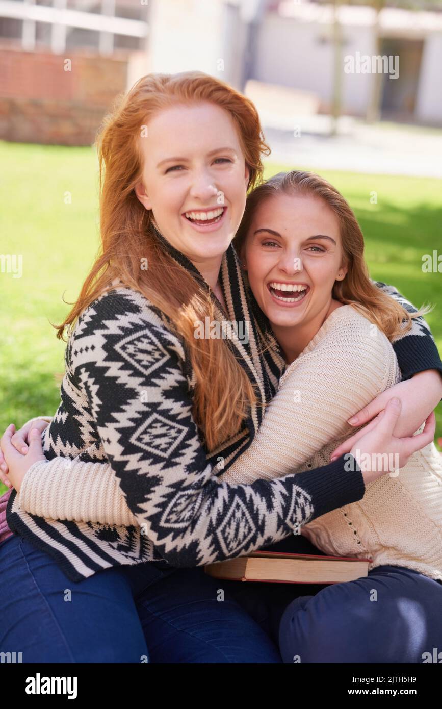 Forging life long friendships at college. two happy friends hugging ...