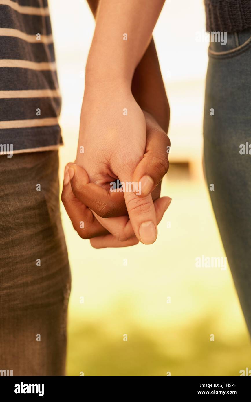 They fit perfectly together. a couple holding hands Stock Photo - Alamy