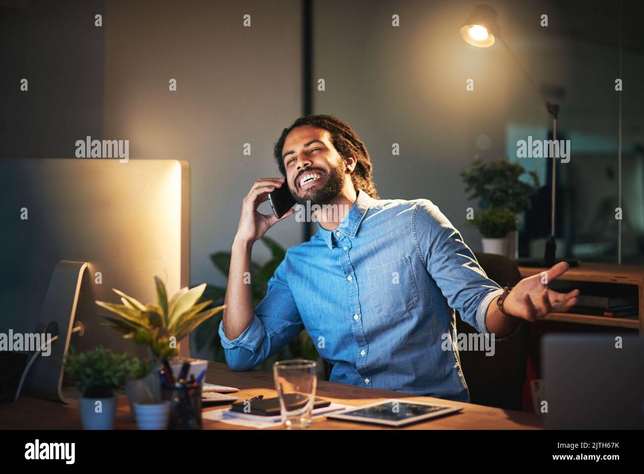 Handling business like a pro. a young designer talking on a cellphone ...