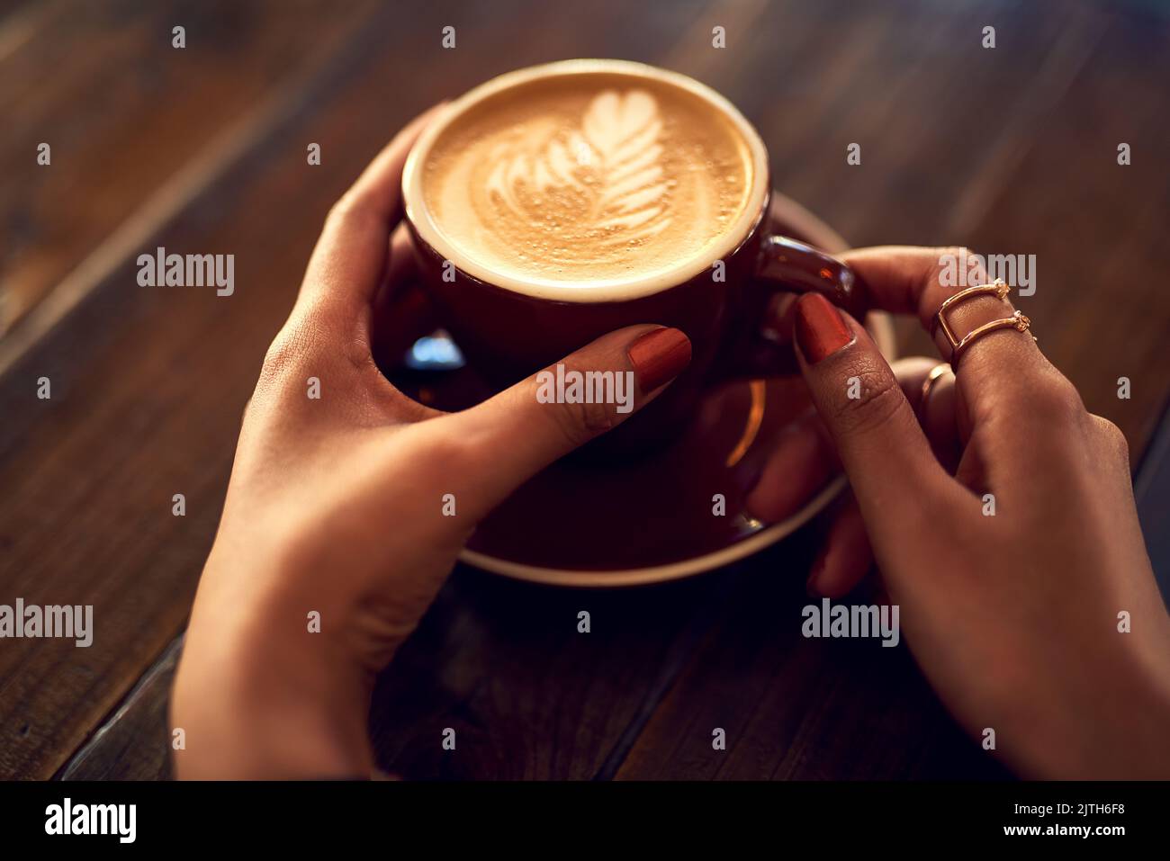 Hug in a mug. Closeup shot of an unidentifiable woman enjoying a cup of ...
