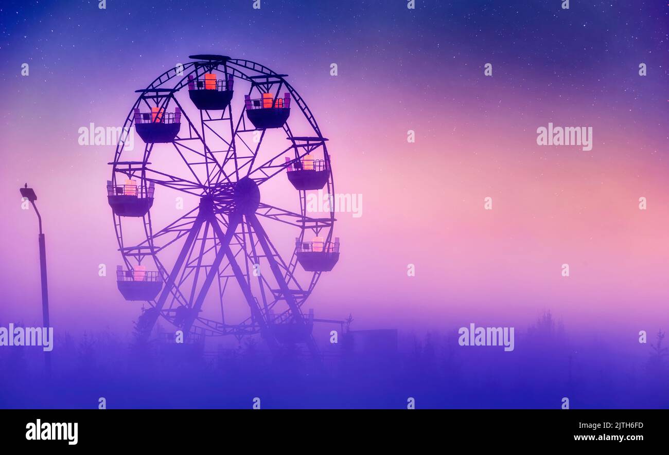 Ferris wheel in the park at dawn. Wonderful summer landscape. The sun's ...