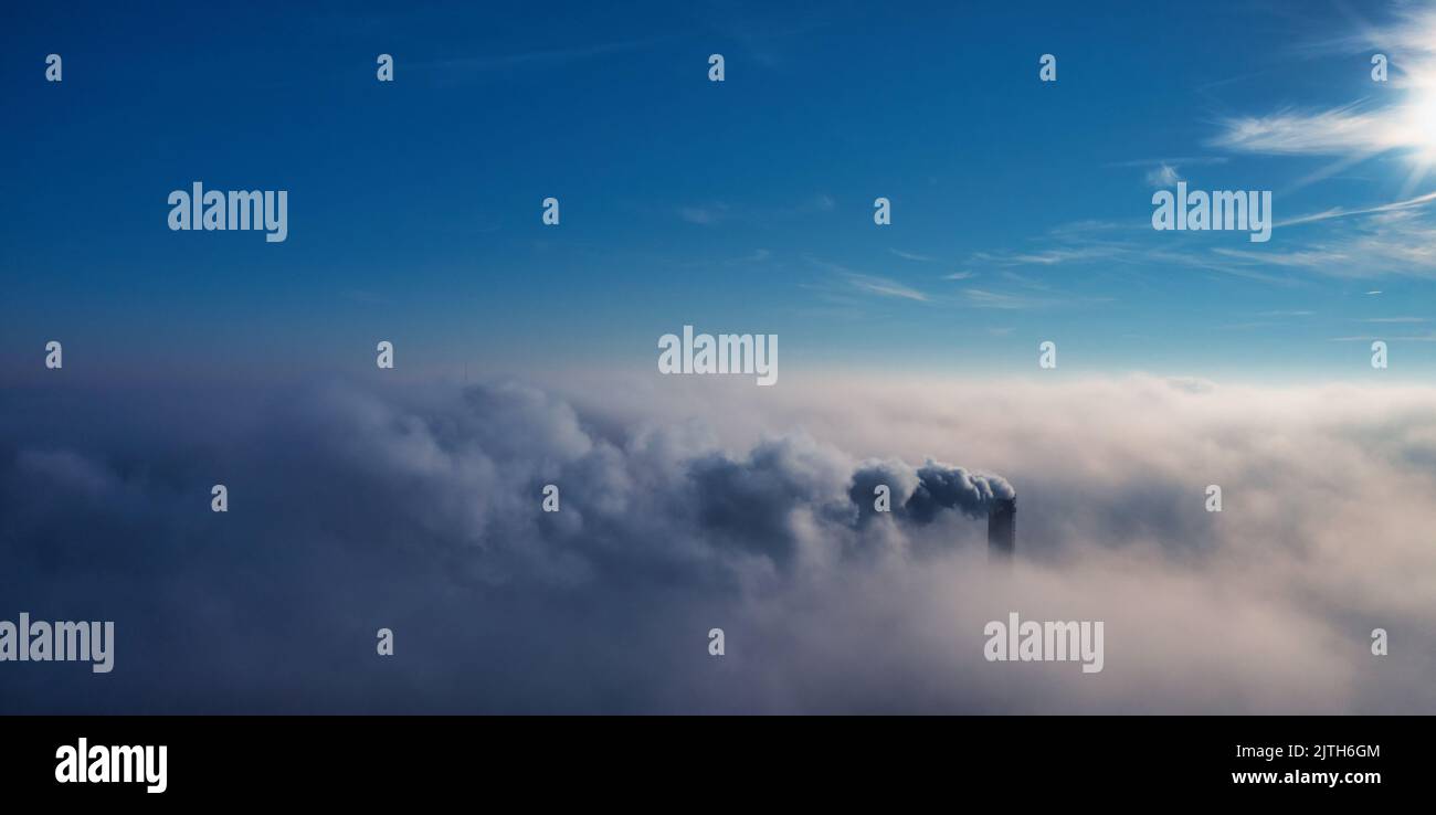 Plant pipe high above the clouds. Harmful emissions into the upper atmosphere. Climate change ...