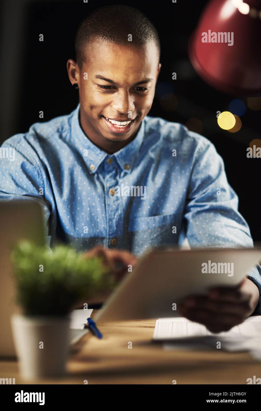 Hes making real progress. a handsome young man working late in the ...