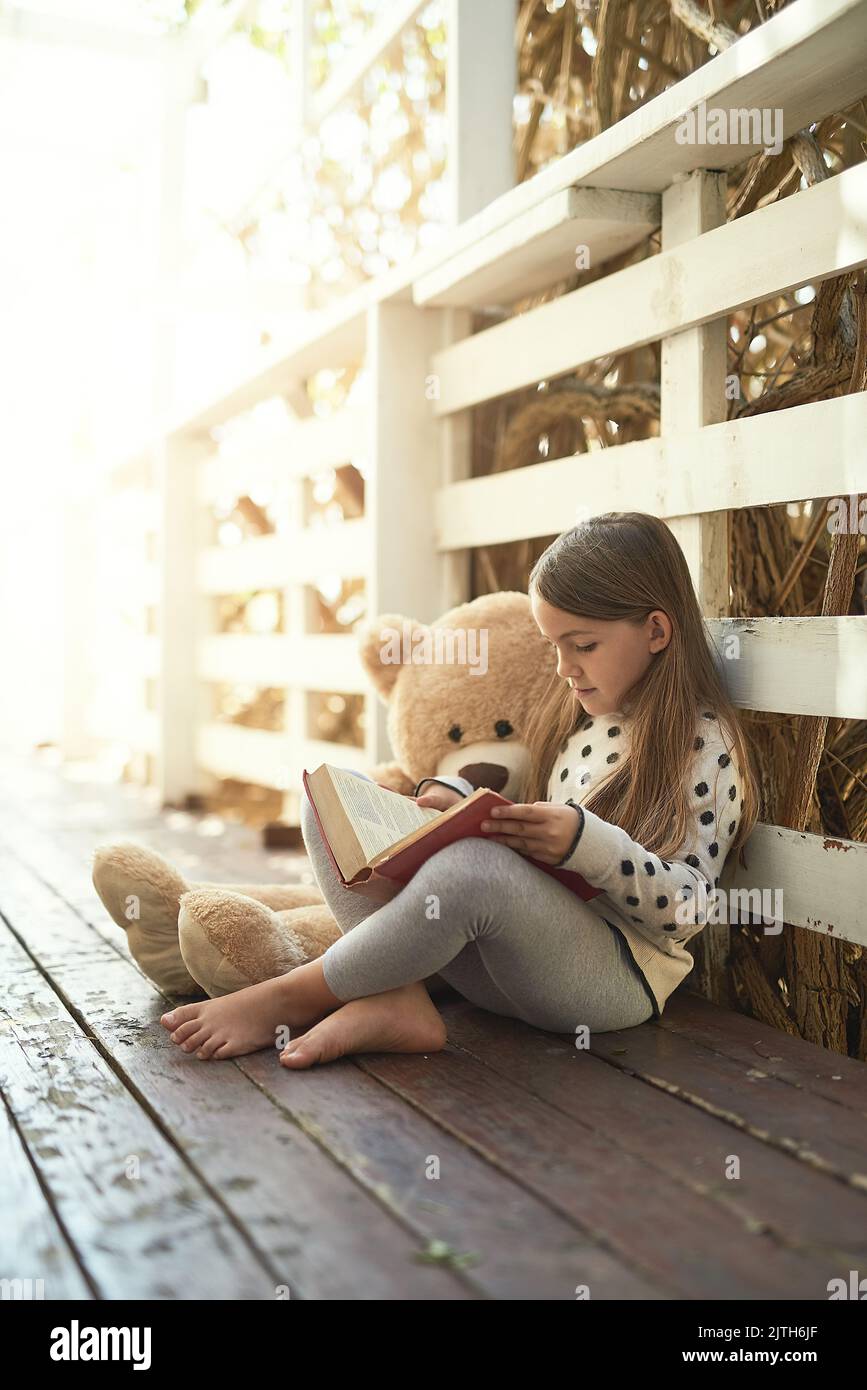 Theyre both engrossed in a good story. a little girl reading a book ...
