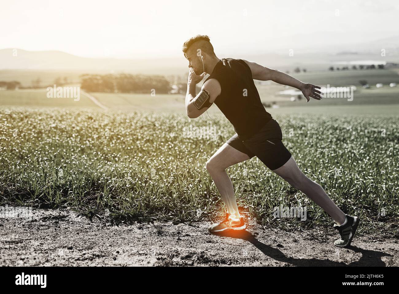 Pushing past the pain. Full length shot of a young man running with an ...