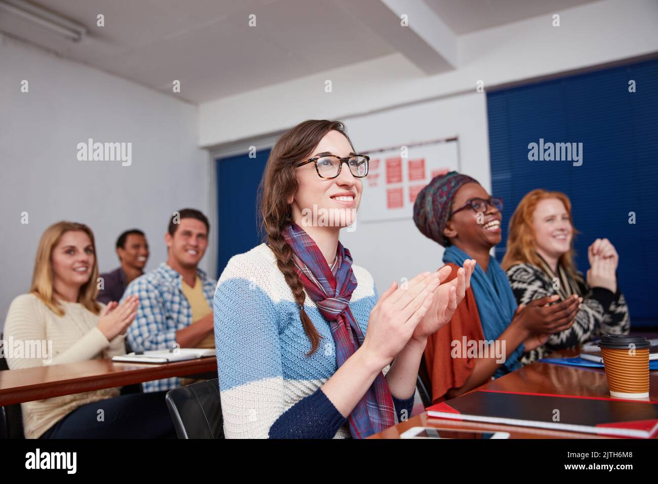 Happy students clapping hands hi-res stock photography and images - Alamy