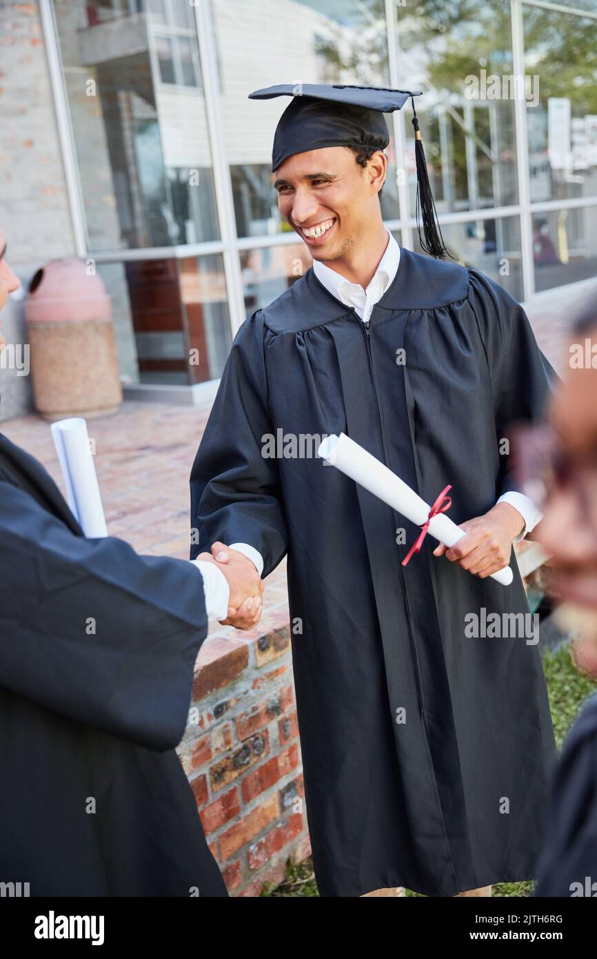 You deserve it. two male students congratulating each other on ...