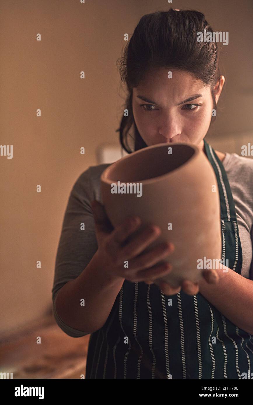 Crafting her latest design. a ceramic artist working on her pottery in ...