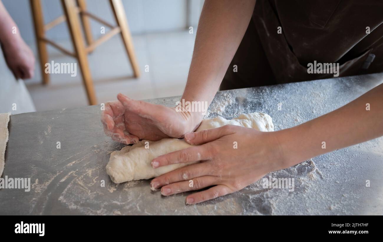 The process of making traditional French baguettes. Forming a blank ...