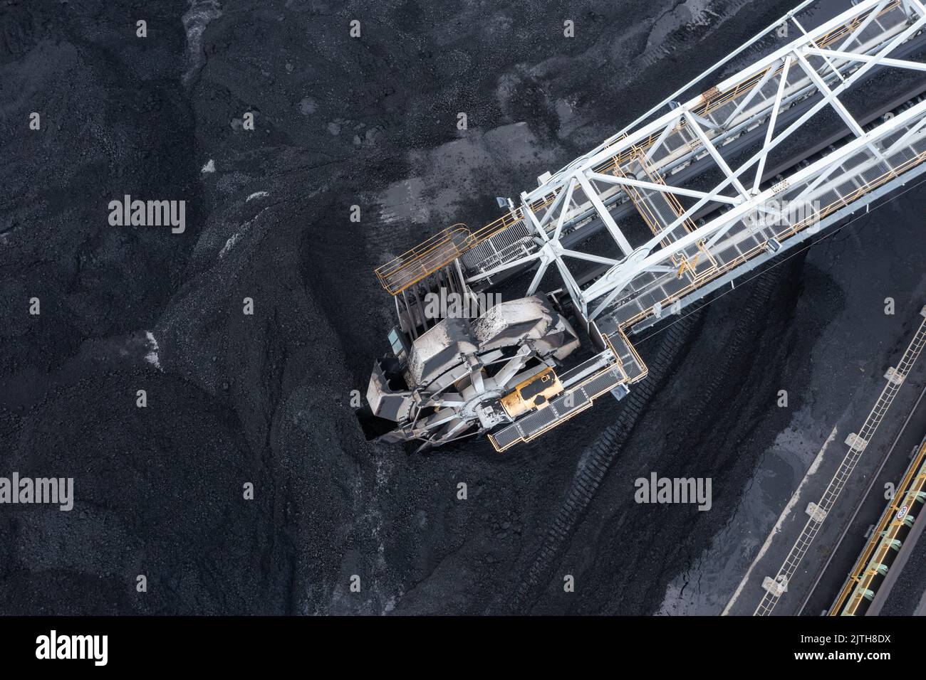 The coal terminal with technics working in it. Works excavator Stock ...