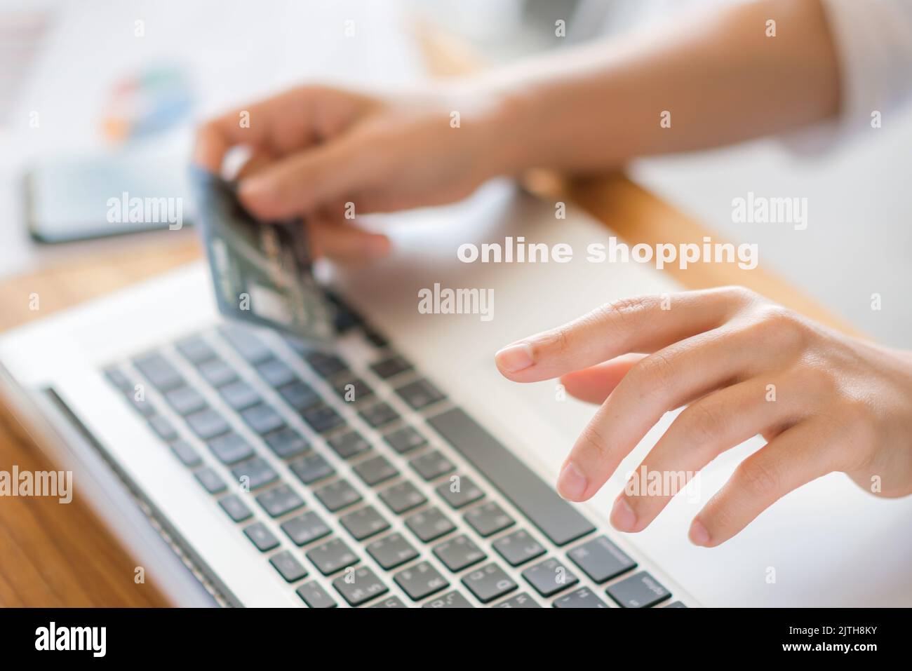 Hands holding a credit card and using laptop computer for online ...