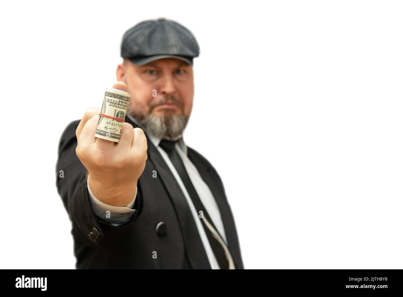 A man shows the middle finger on which dollars are rolled up into a ...