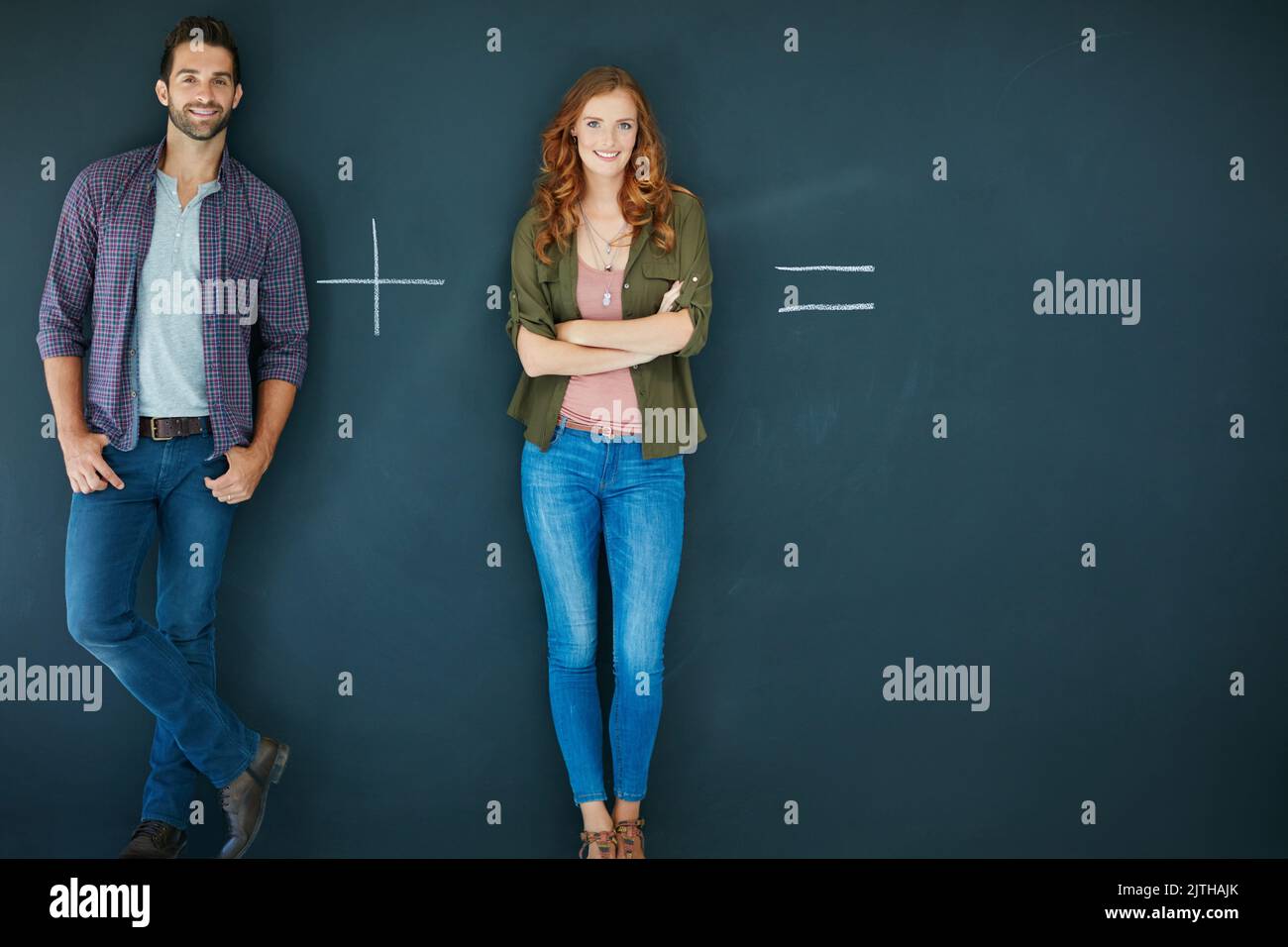 You plus me equals...a young couple standing in front of a blackboard ...