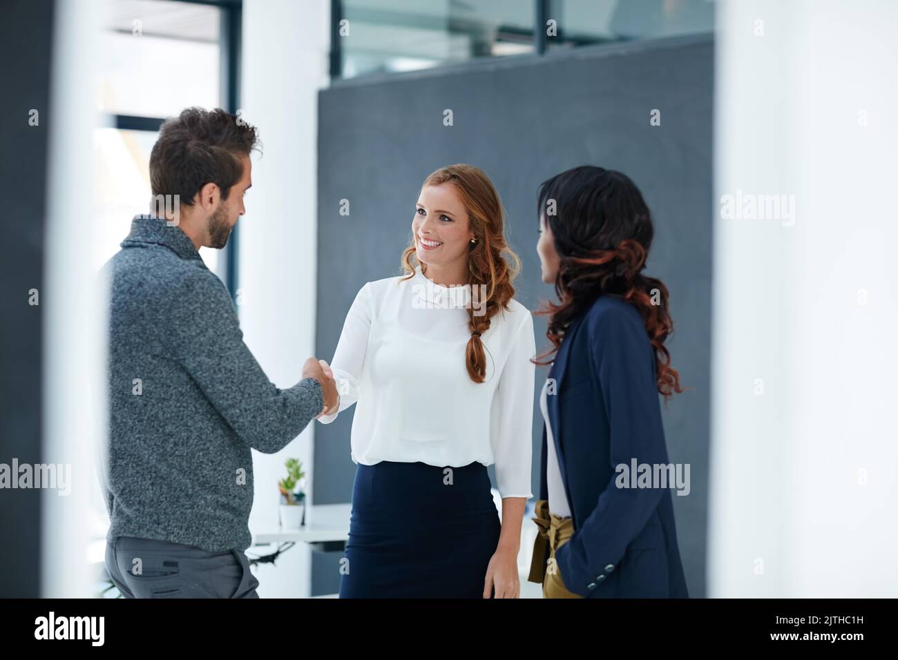 Strengthening partnerships through teamwork. businesspeople shaking ...