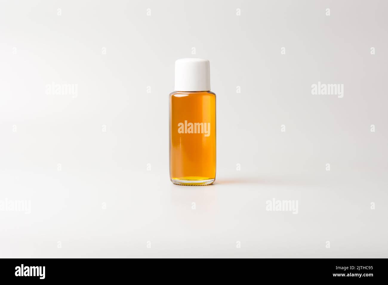 small oil bottle with white cap, mock-up template, isolated on gray ...